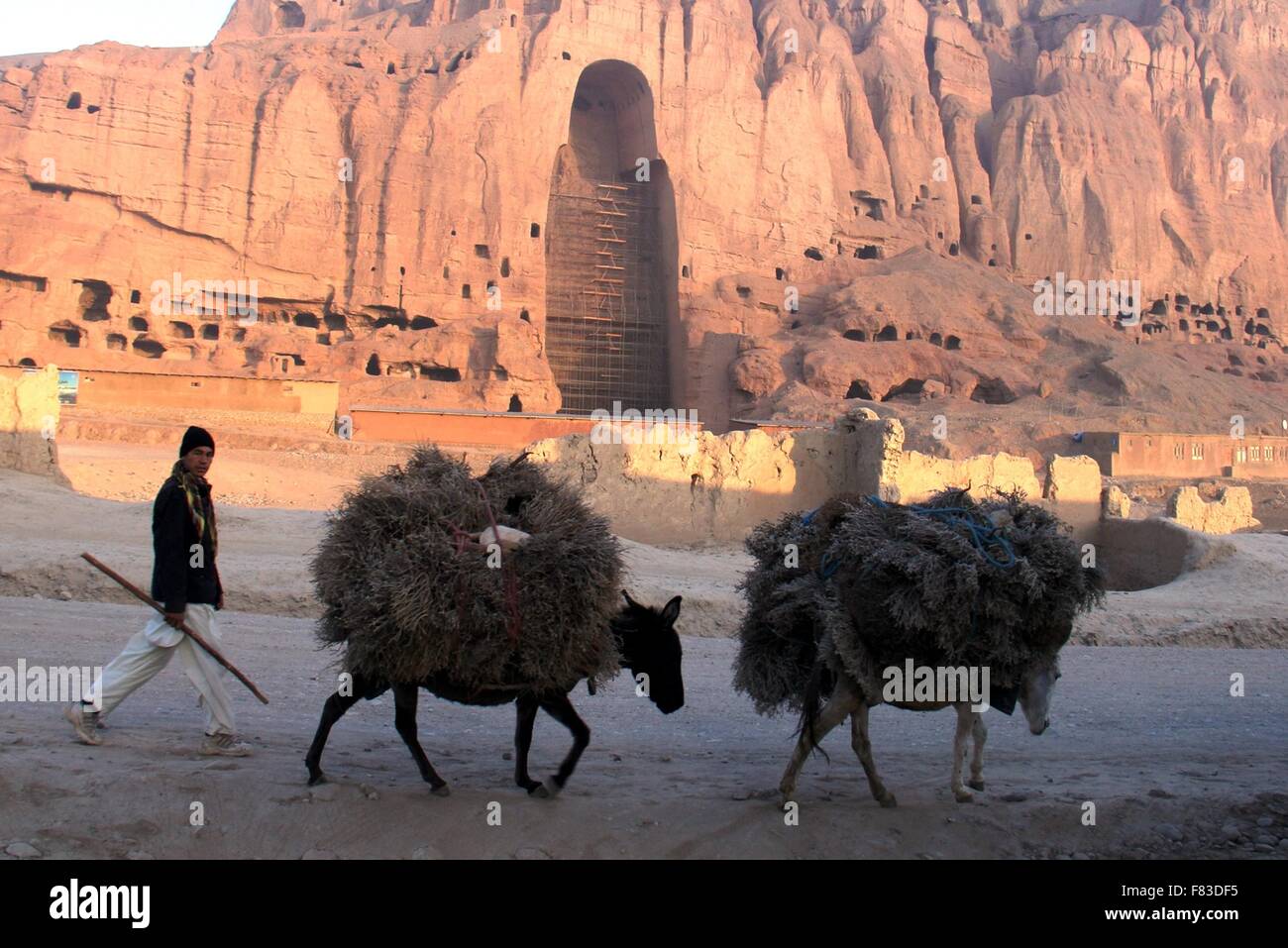 Bamyan, Afghanistan. 5th Dec, 2015. An Afghan man passes by the remains ...
