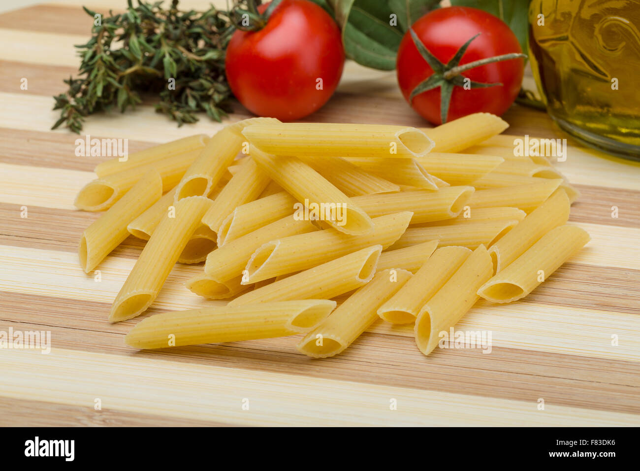 Raw penne pasta on the wood background Stock Photo - Alamy