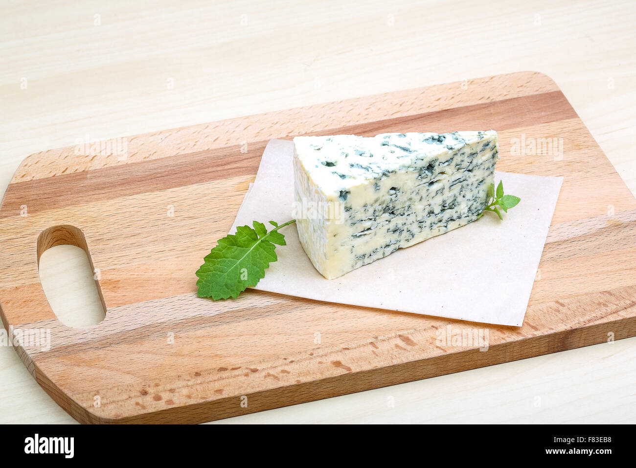 Dor Blue cheese with basil on the wood background Stock Photo - Alamy