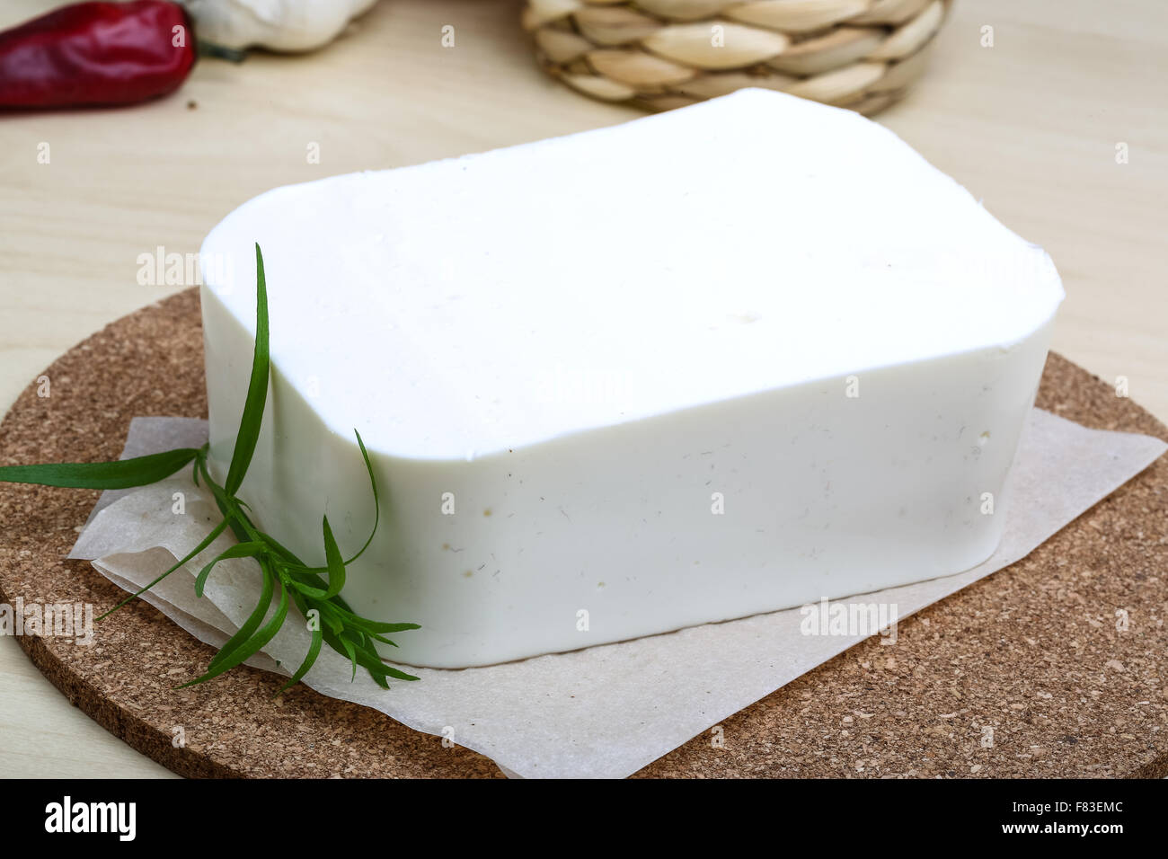 Feta cheese slice on the board with terragon Stock Photo - Alamy