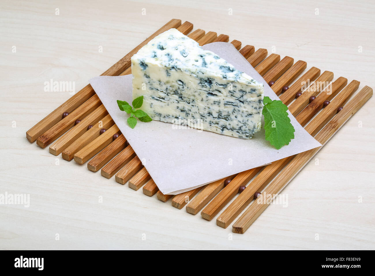 Dor Blue cheese with basil on the wood background Stock Photo - Alamy