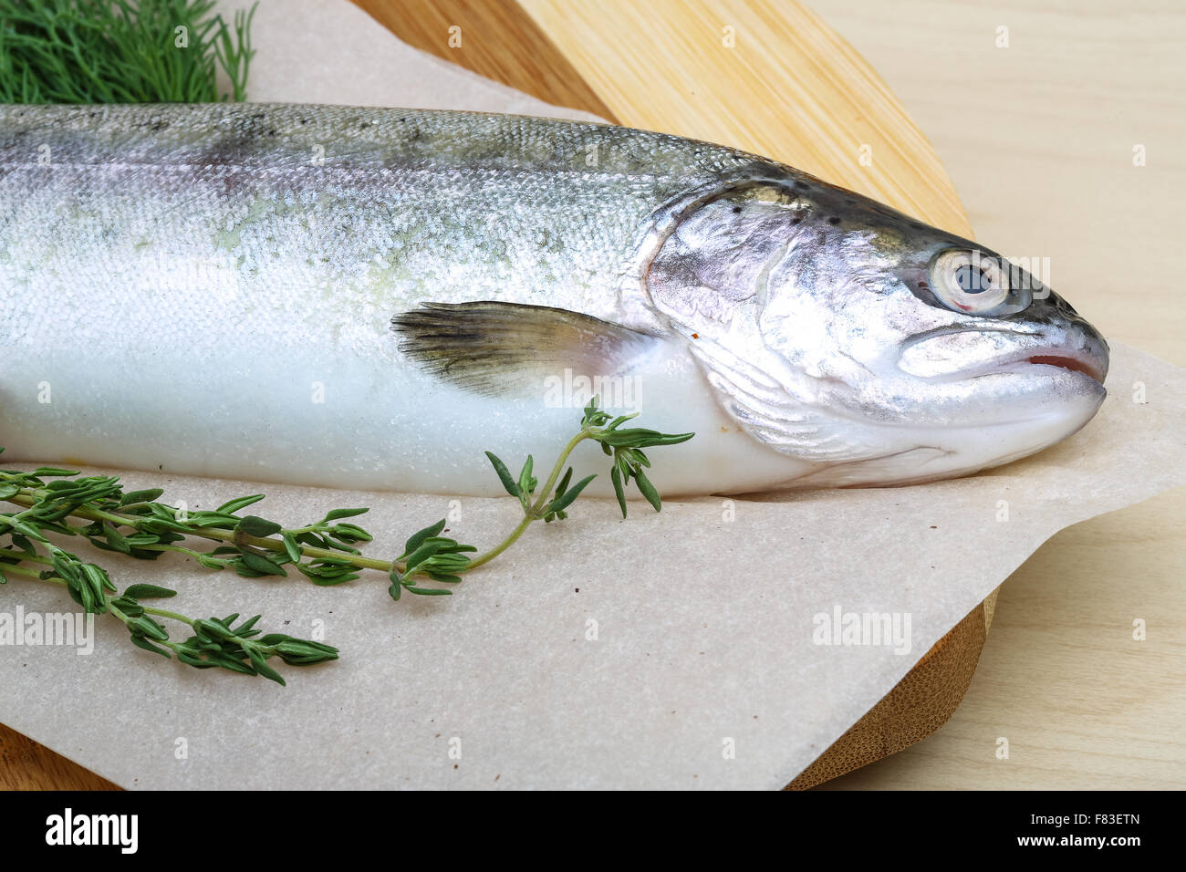 Raw trout with thyme and dill - ready for cooking Stock Photo - Alamy