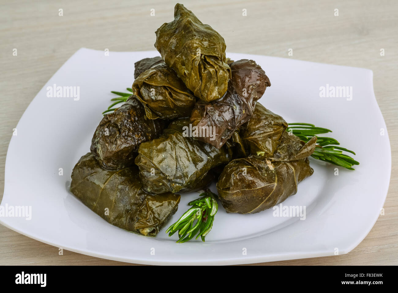 Greek dolma in grape leaves with meat served rosemary Stock Photo - Alamy