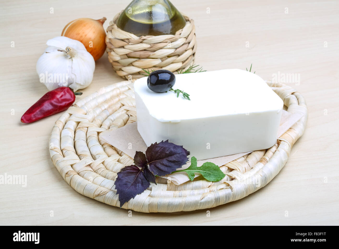 Feta cheese slice on the board with herbs Stock Photo - Alamy