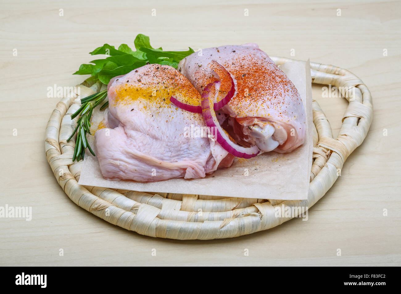 Two Raw chicken thights with herbs and spices Stock Photo - Alamy