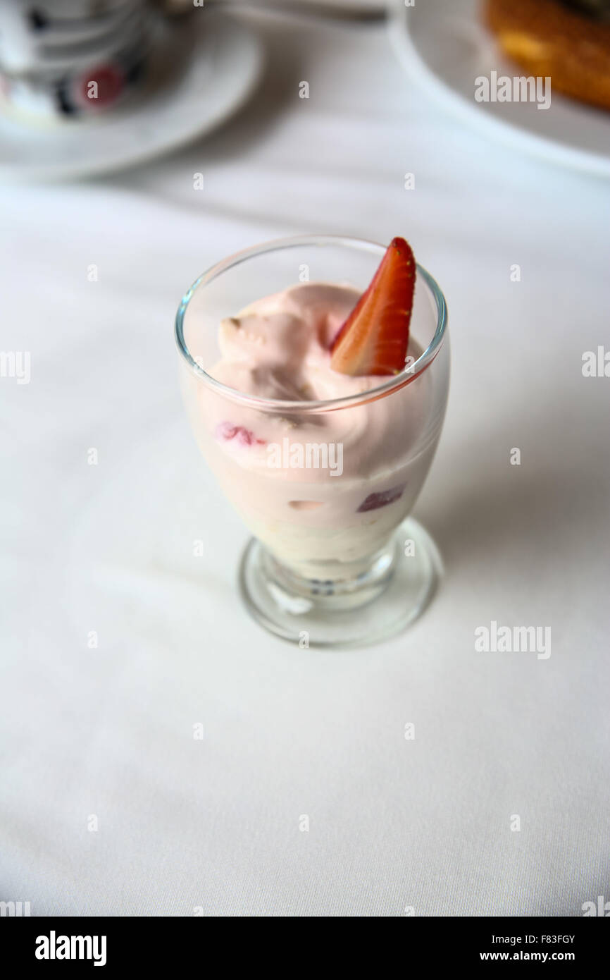 Pink Yoghurt with fresh red strawberry slice Stock Photo - Alamy