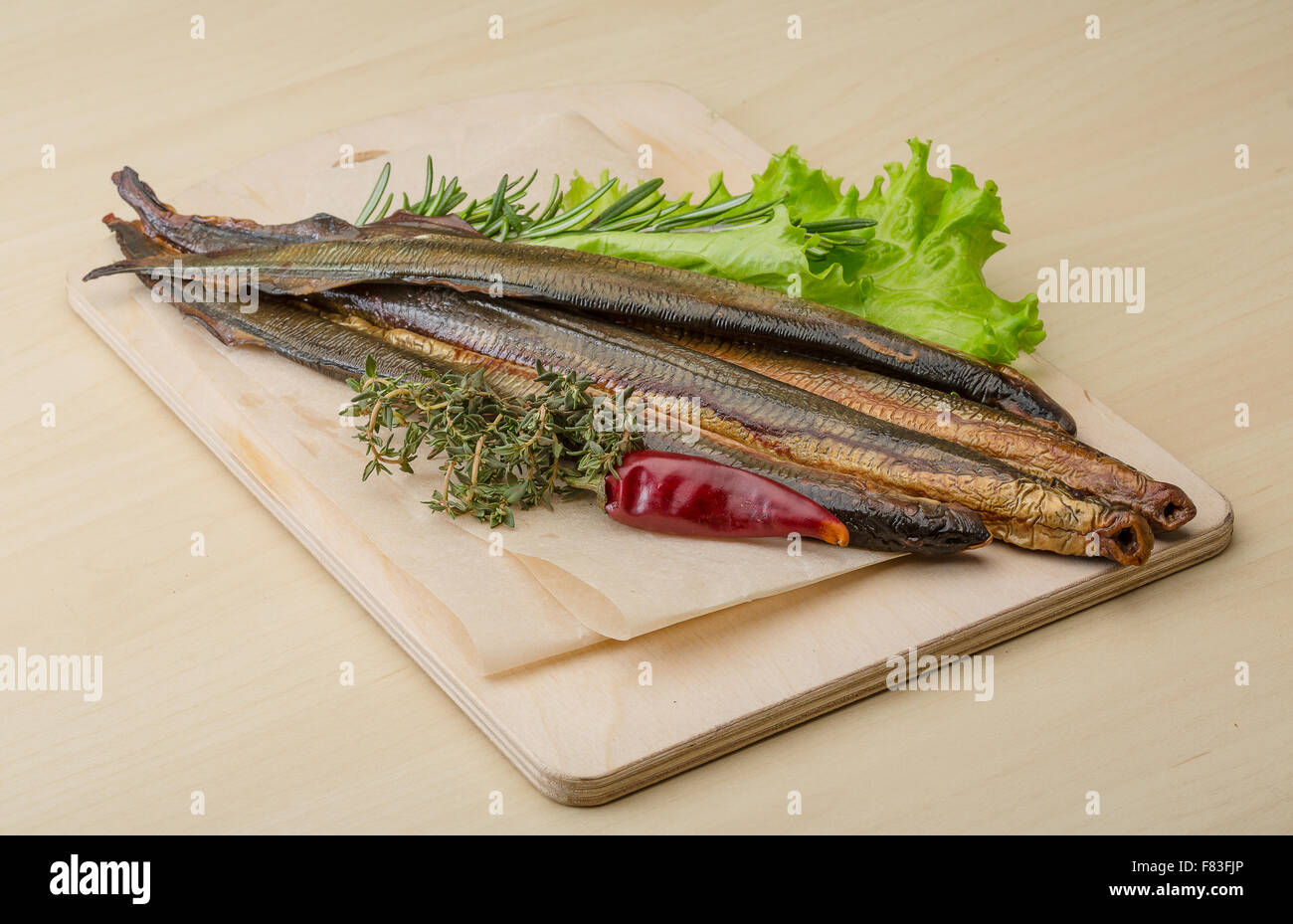 Smoked Lamprey - seafood delicacy with salad and herbs Stock Photo - Alamy