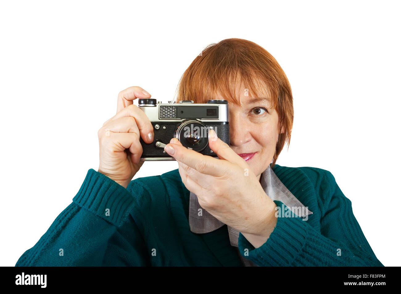 Senior woman taking photo with vintage camera over white background ...