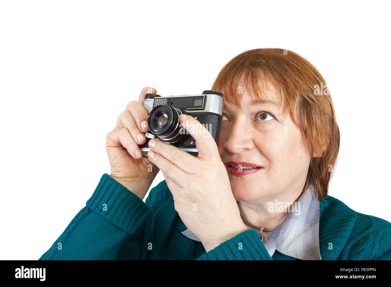 Senior woman taking photo with vintage camera over white background ...