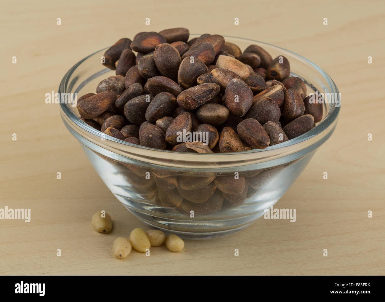 Brown Cedar nut on the wood background Stock Photo - Alamy