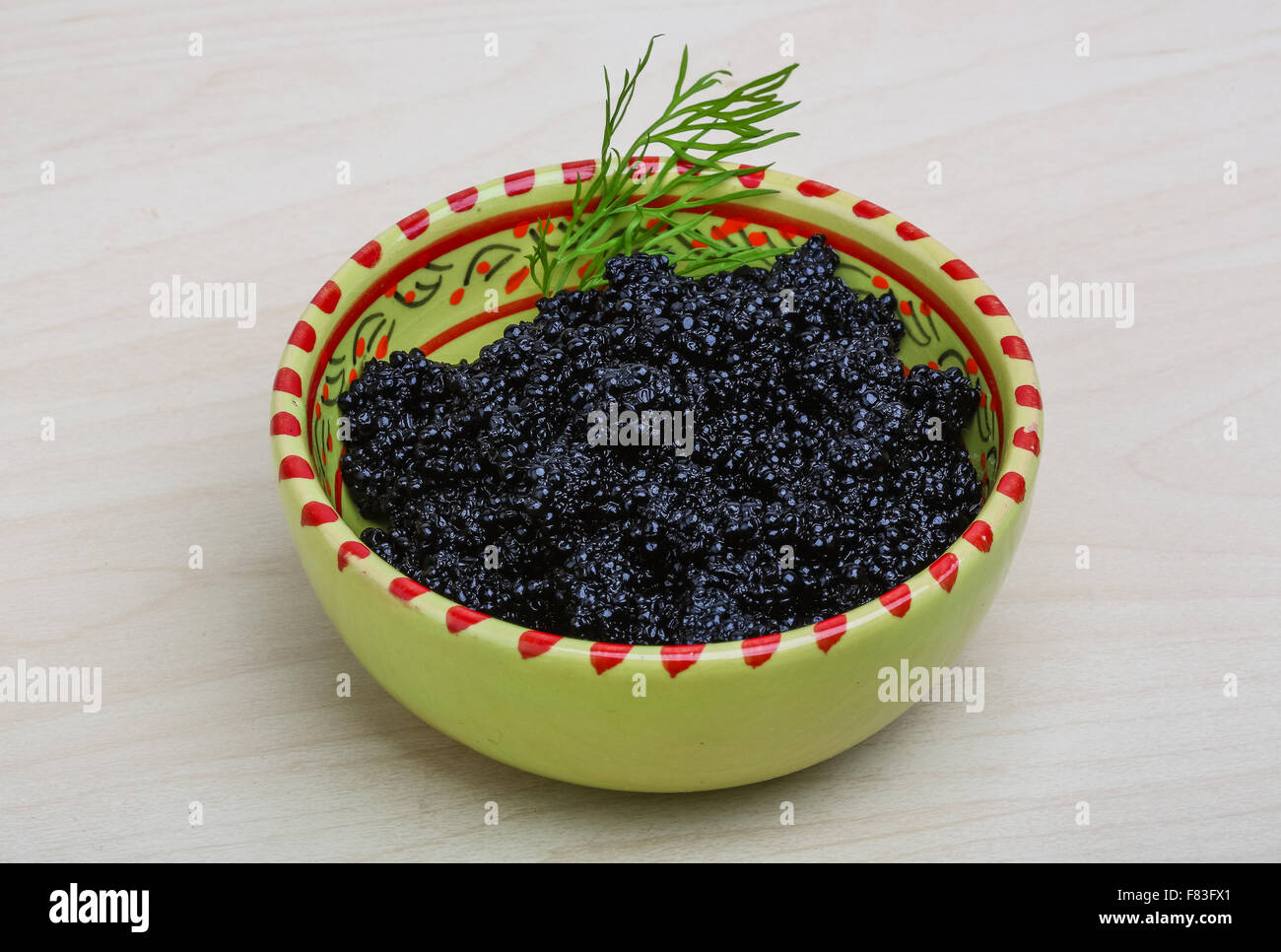 Luxury Black caviar with green herb and lemon Stock Photo - Alamy