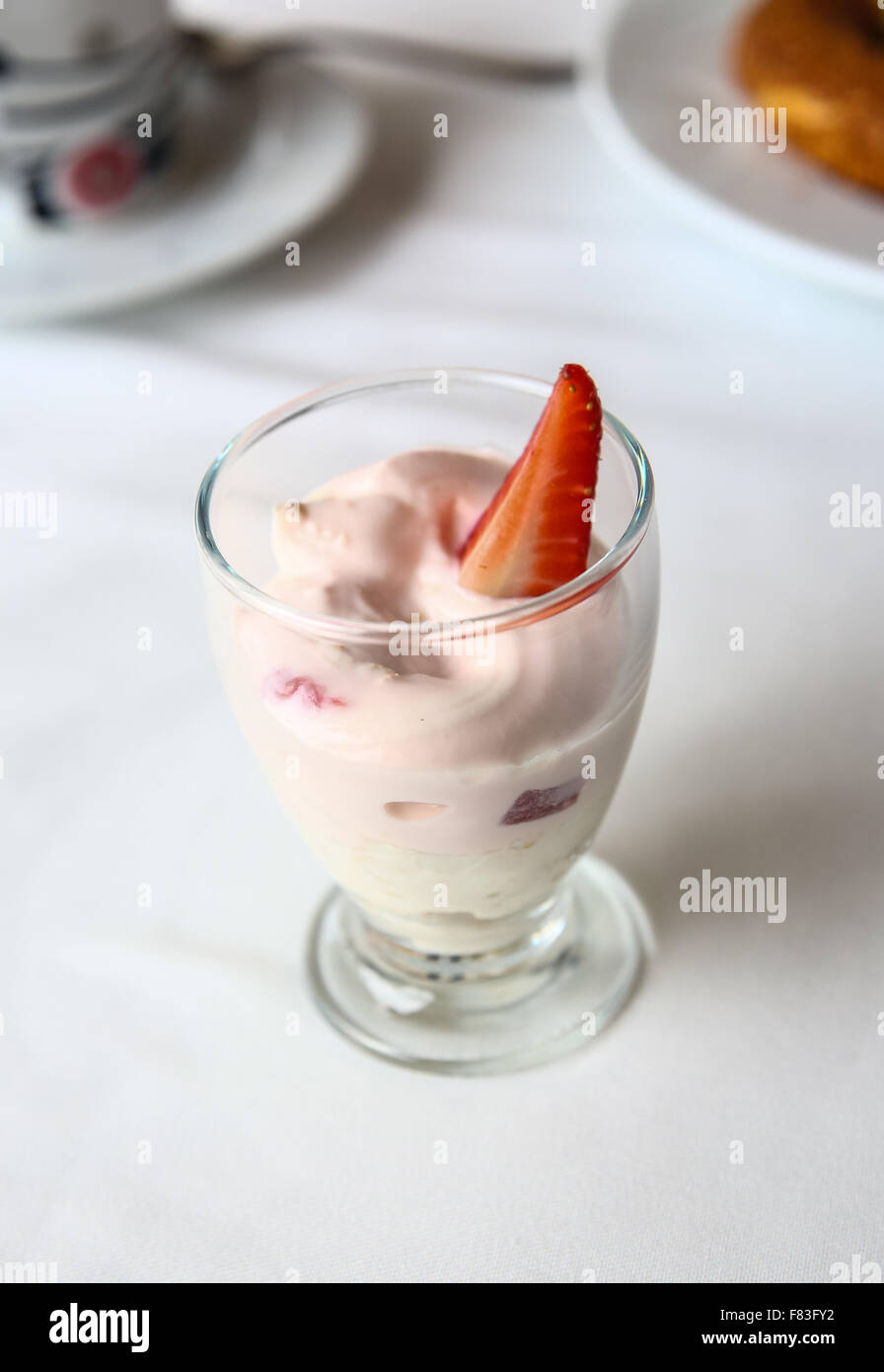 Pink Yoghurt with fresh red strawberry slice Stock Photo - Alamy