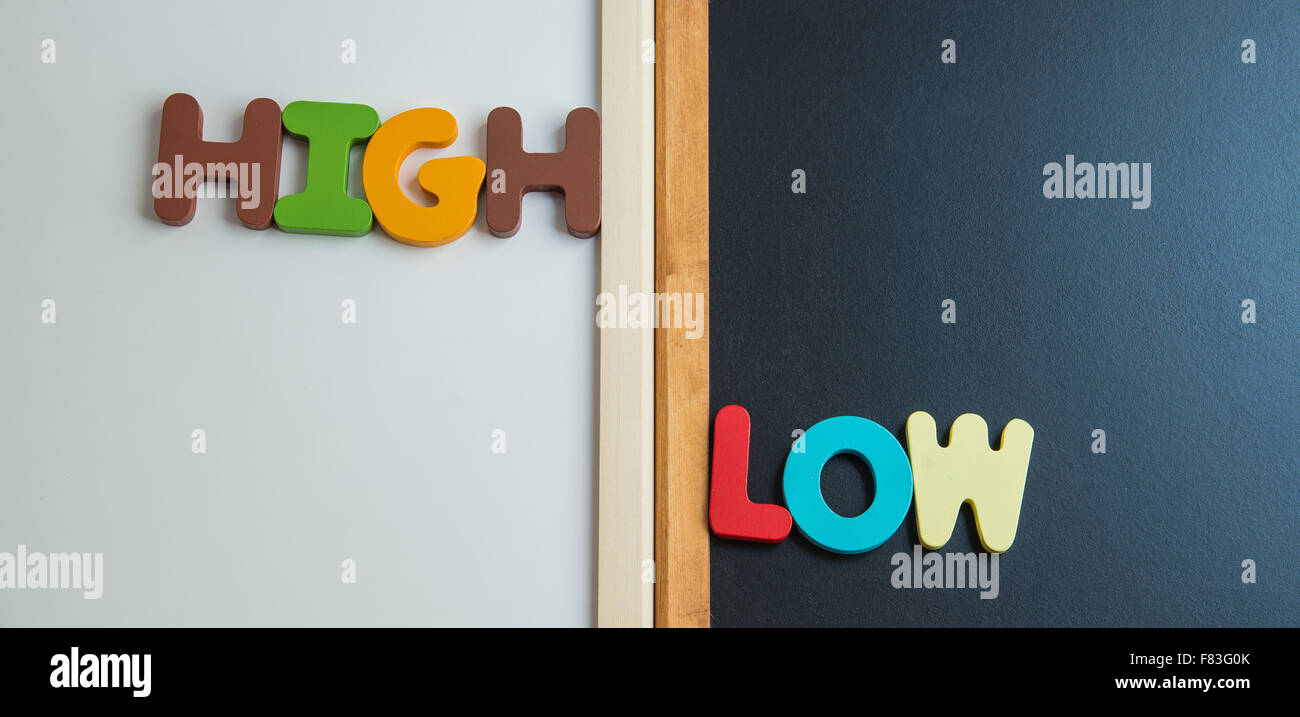 Wooden word HIGH and LOW on black board and white board Stock Photo - Alamy