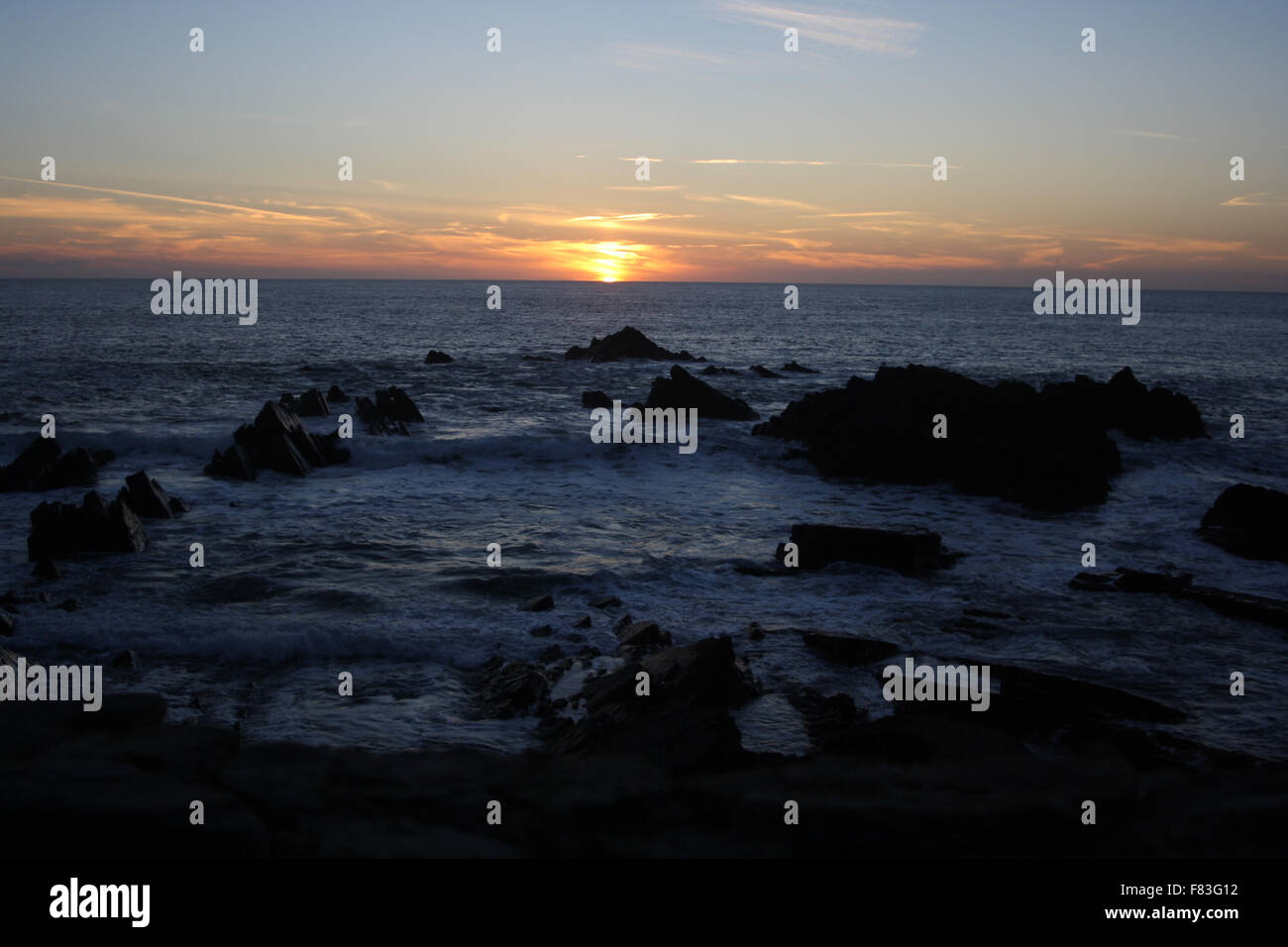 Hartland Point sunset and rocks Stock Photo - Alamy