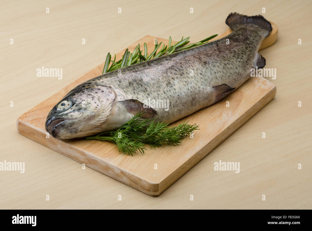 Raw fresh trout on the wood background with herbs Stock Photo - Alamy