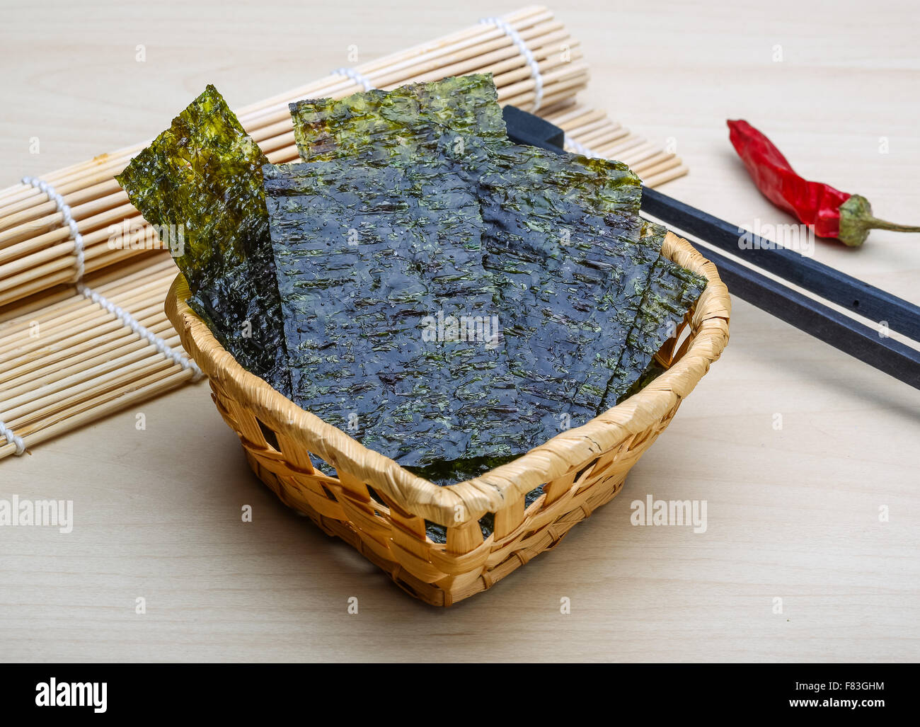 Nori sheets with sticks on the wood background Stock Photo - Alamy