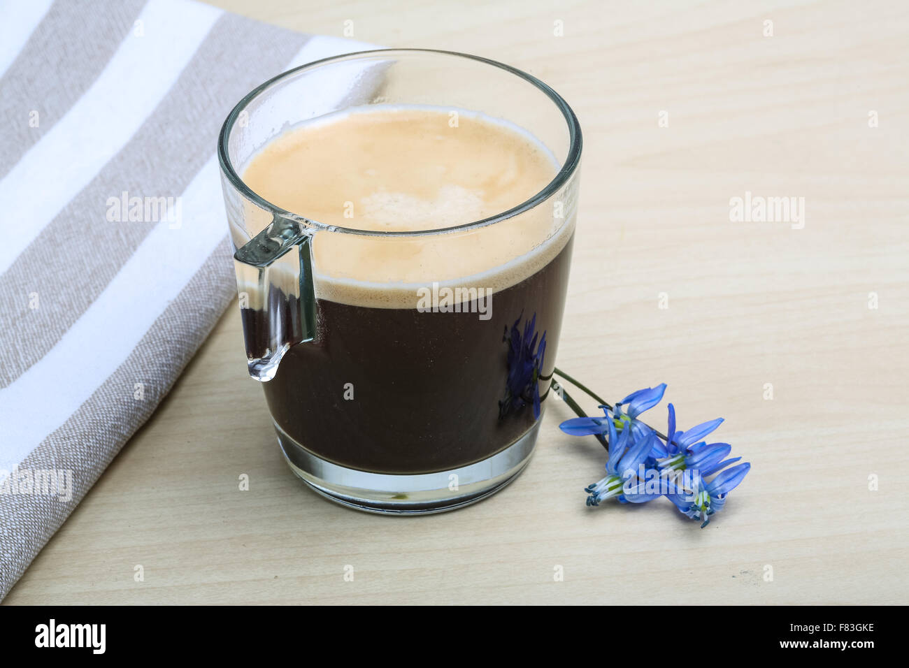 Hot Espresso coffee with blue spring flowers Stock Photo - Alamy