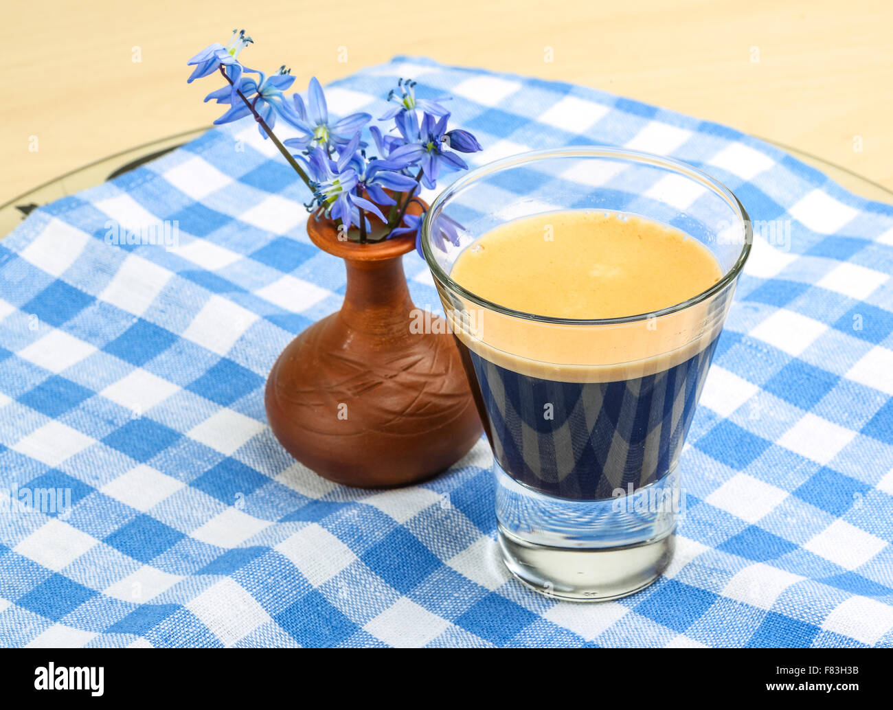 Hot Espresso coffee with blue spring flowers Stock Photo - Alamy