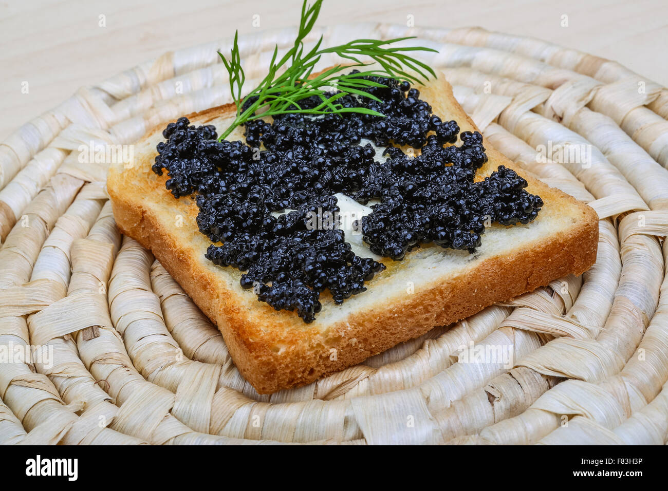 Black caviar toast with green dill branch Stock Photo - Alamy