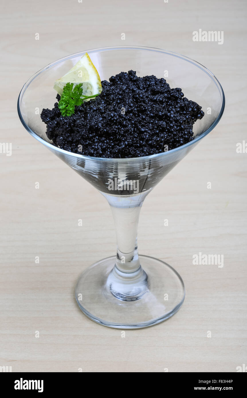 Luxury Black caviar with parsley and lemon Stock Photo - Alamy