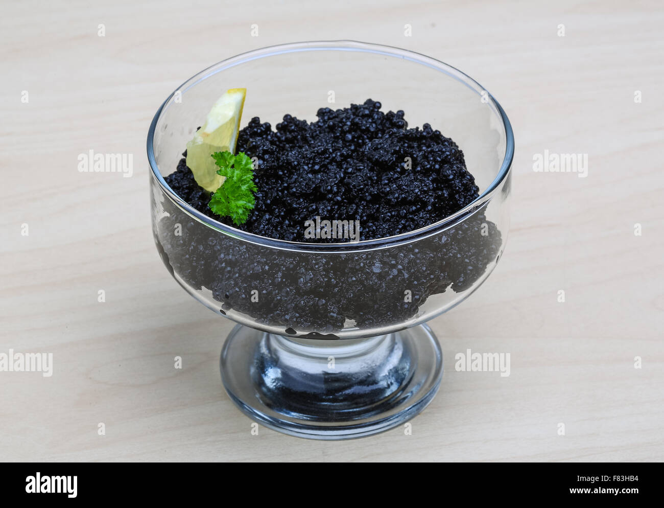 Luxury Black caviar with parsley and lemon Stock Photo - Alamy