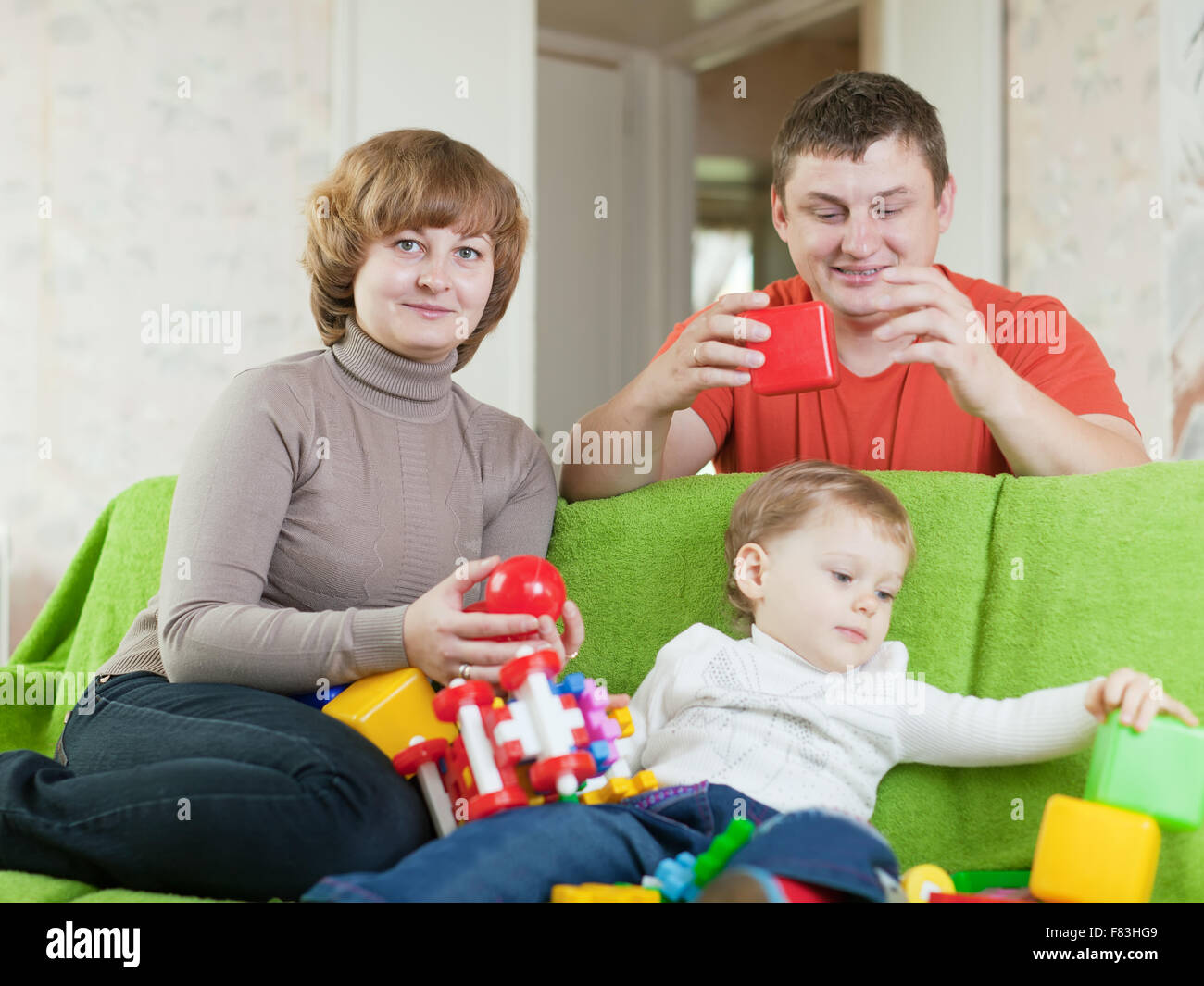 Portrait of family of three in home Stock Photo - Alamy
