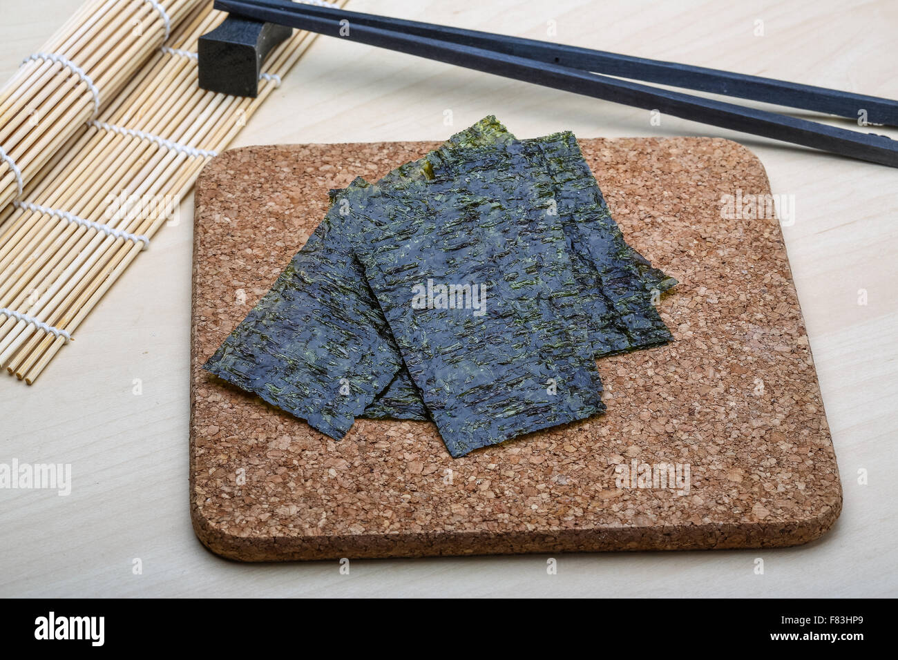 Nori sheets with sticks on the wood background Stock Photo - Alamy
