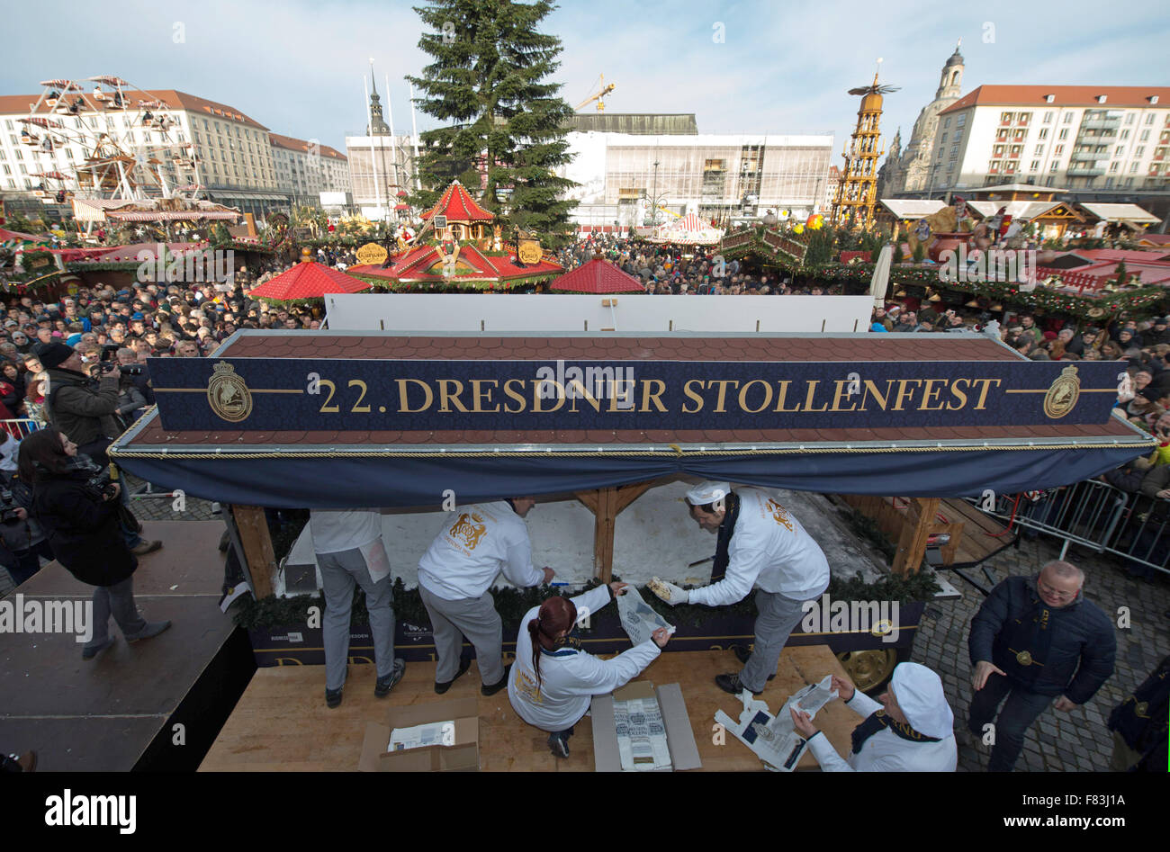 Dresden, Germany. 5th Dec, 2015. Bakers cut up a giant stollen cake at ...