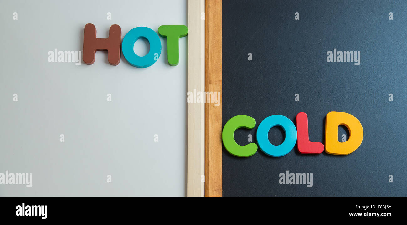 Wooden word HOT and COLD on black board and white board Stock Photo - Alamy