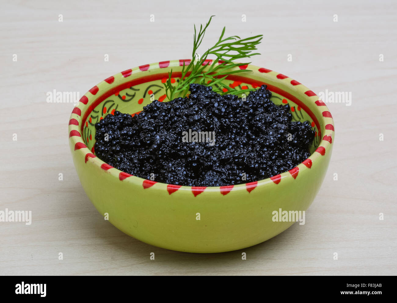 Luxury Black caviar with green herb and lemon Stock Photo - Alamy