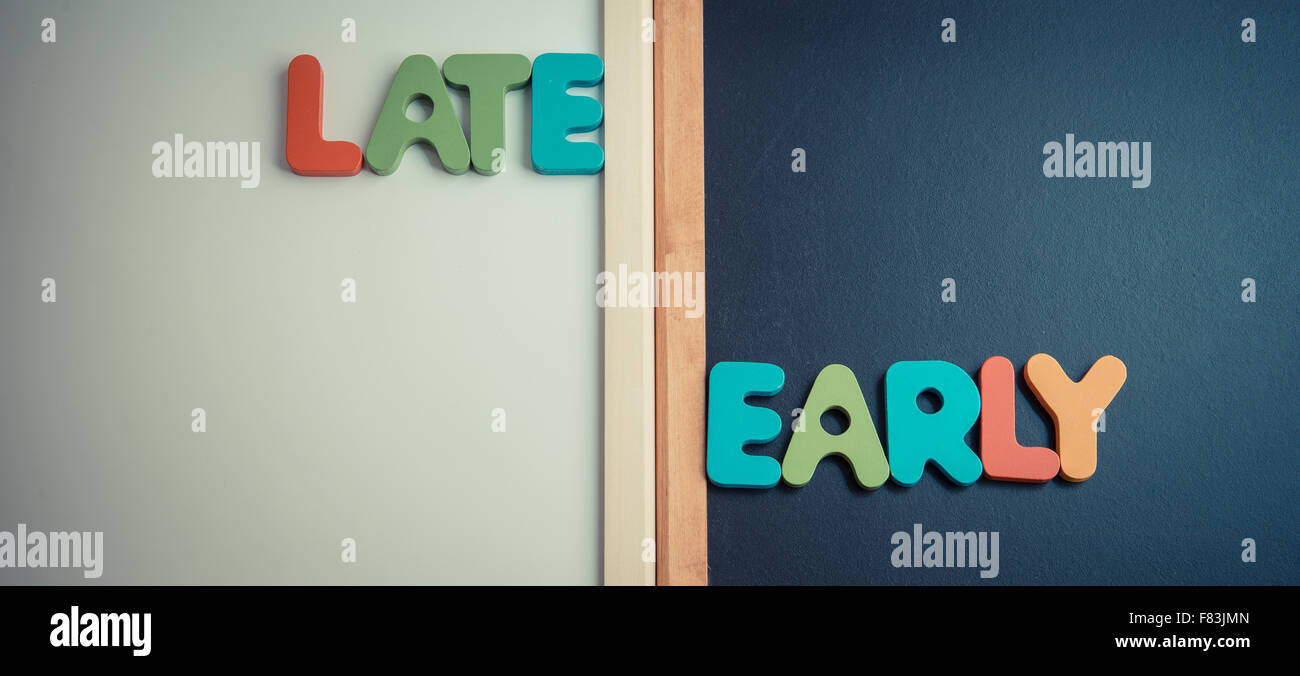 Wooden word LATE and EARLY on black board and white board in Vintage ...
