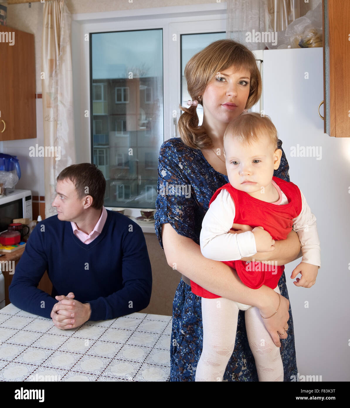 Family of three having quarrel at home Stock Photo - Alamy
