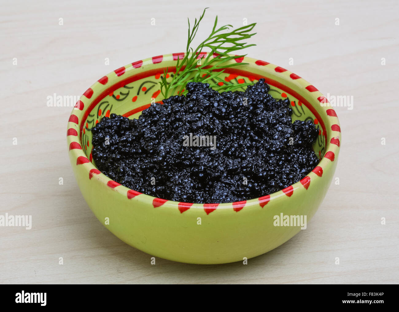 Luxury Black caviar with green herb and lemon Stock Photo - Alamy