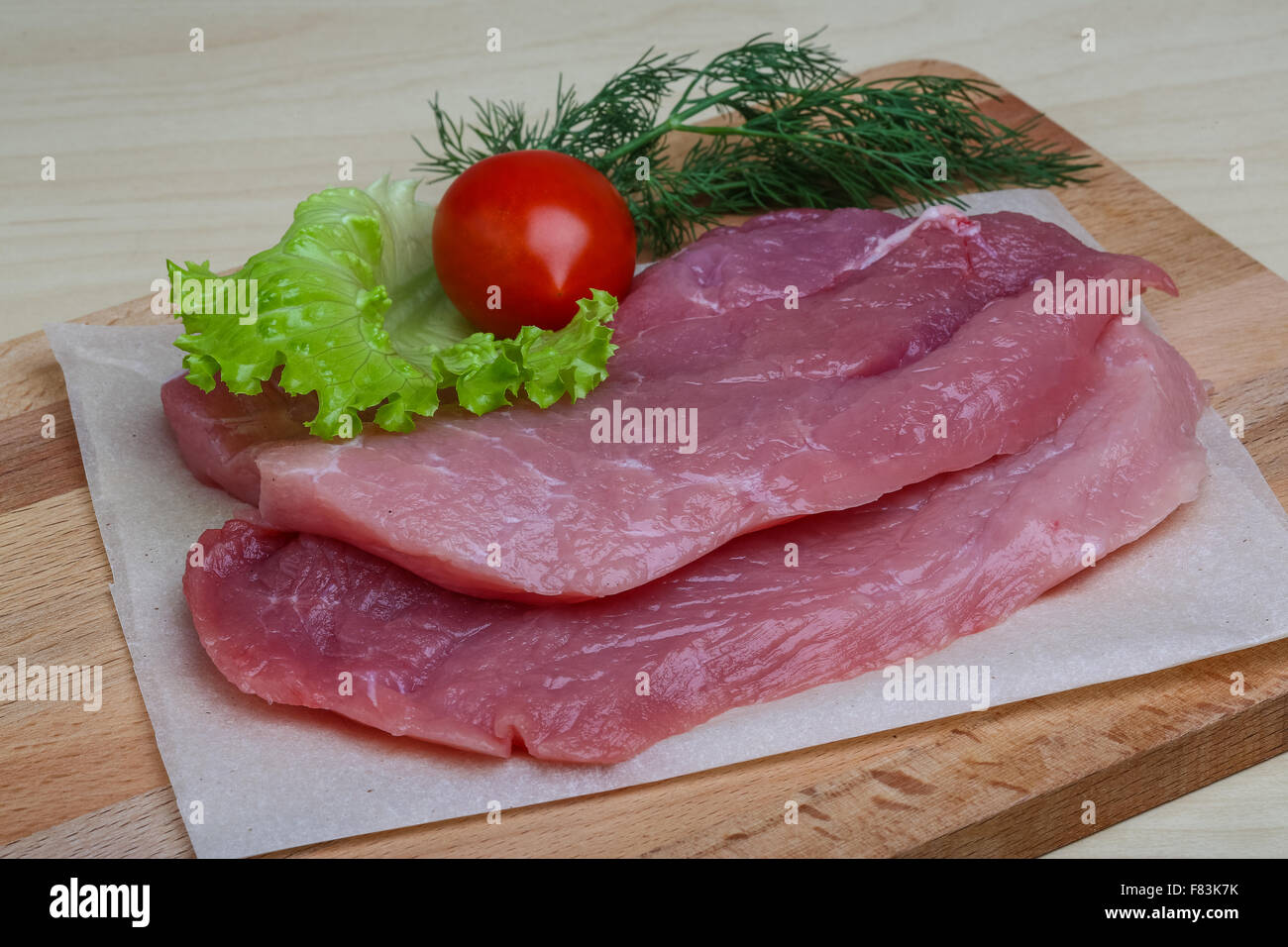 Raw pork schnitzel with dill - ready for cooking Stock Photo - Alamy