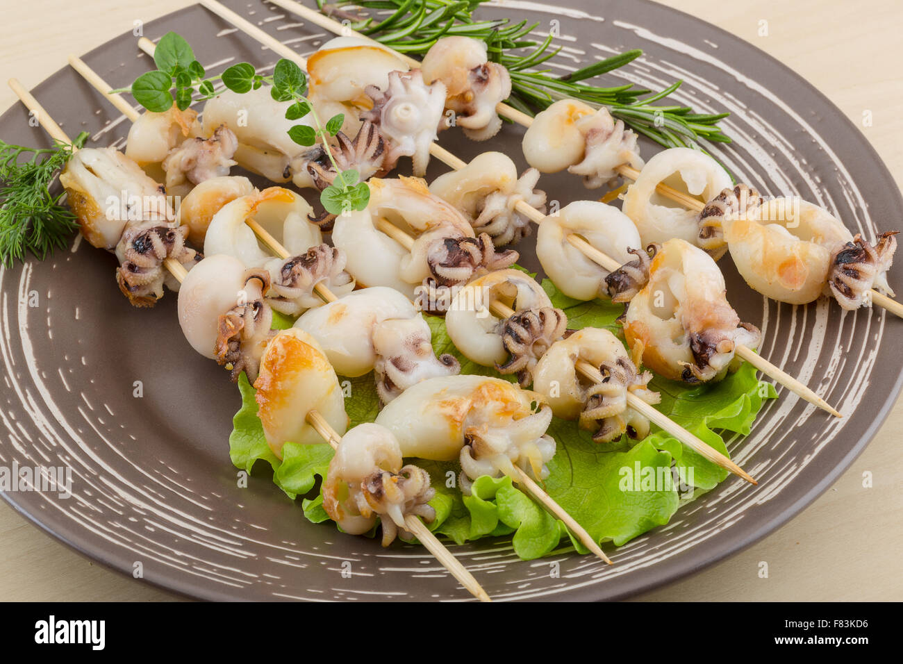 Grilled cuttlefish bbq with rosemary and pepper Stock Photo - Alamy