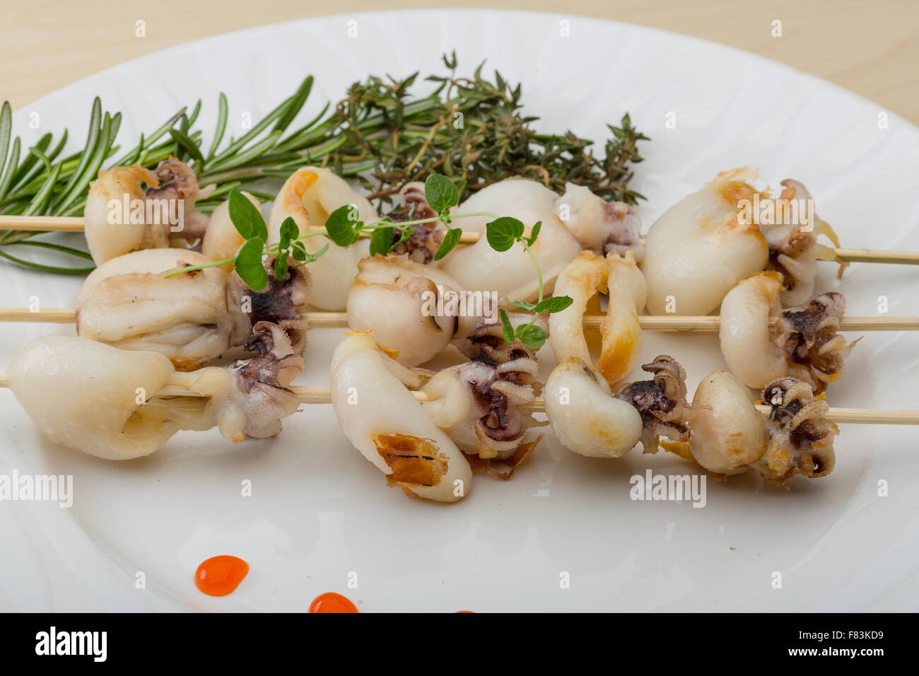 Grilled cuttlefish bbq with rosemary and pepper Stock Photo - Alamy
