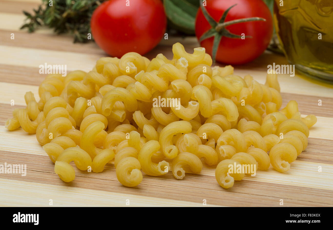 Raw Cellentani pasta on the wood background Stock Photo - Alamy