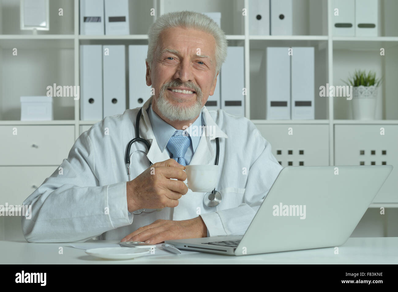 Elderly doctor with laptop Stock Photo - Alamy