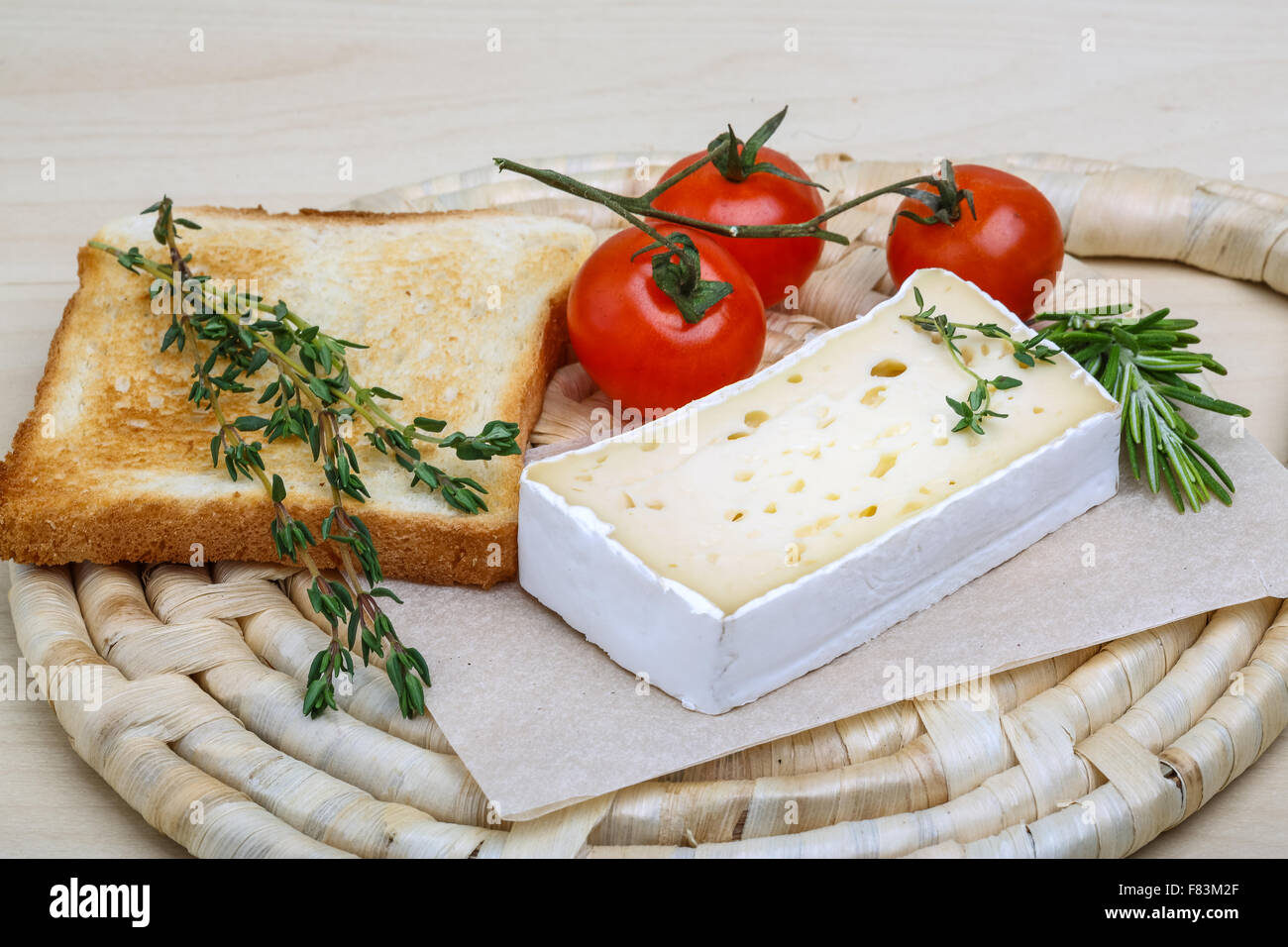 Soft brie cheese with rosemary, thyme and toast bread Stock Photo - Alamy