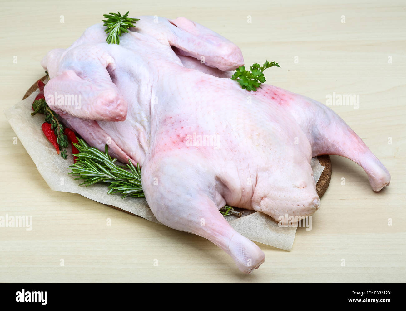 Raw duck with rosemary and spices - ready for cooking Stock Photo - Alamy