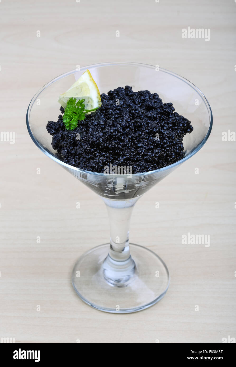 Luxury Black caviar with parsley and lemon Stock Photo - Alamy