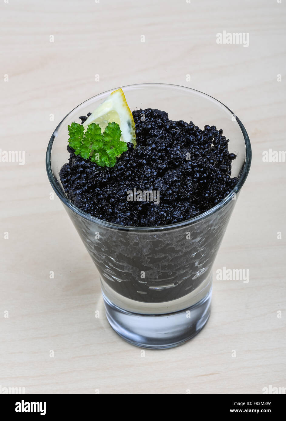 Luxury Black caviar with green herb and lemon Stock Photo - Alamy