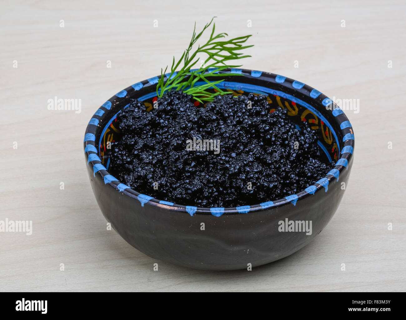 Luxury Black caviar with green herb and lemon Stock Photo - Alamy