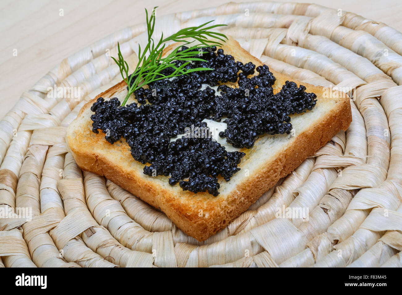 Black caviar toast with green dill branch Stock Photo - Alamy