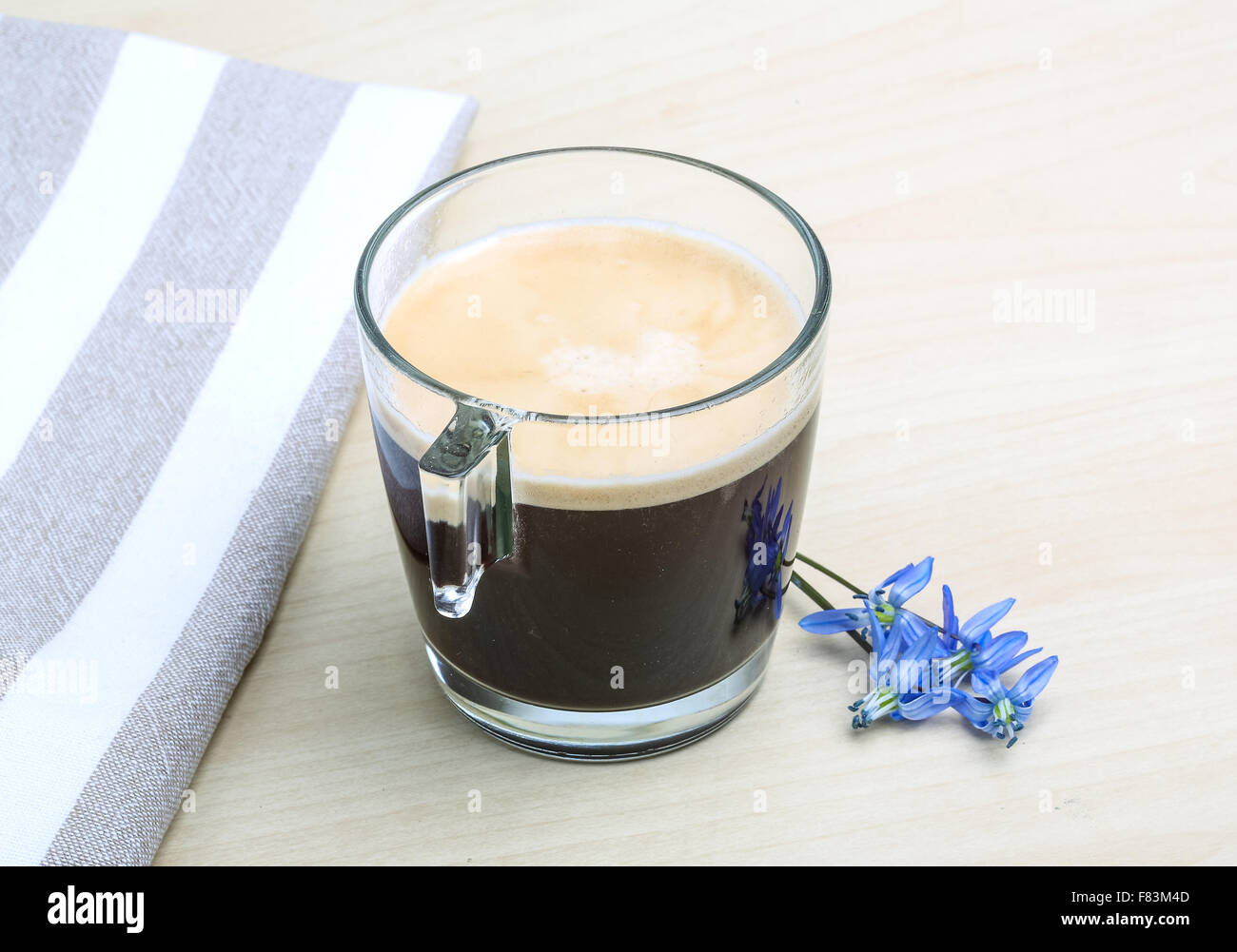 Hot Espresso coffee with blue spring flowers Stock Photo - Alamy