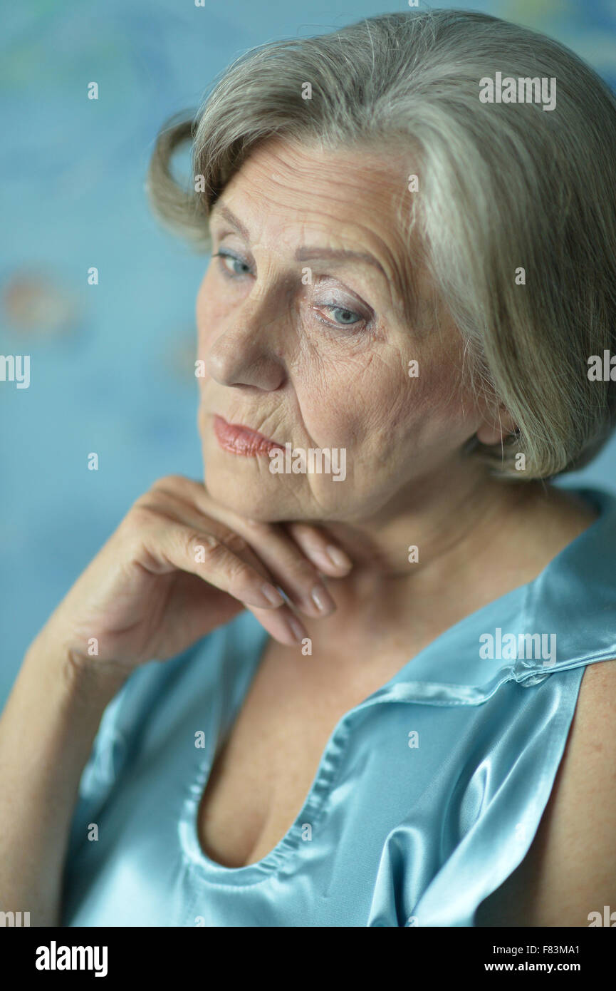 Portrait of thinking elderly woman Stock Photo - Alamy