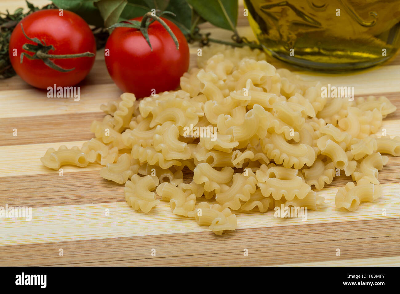 Raw Italian Pasta Creste di gallo on wood background Stock Photo - Alamy