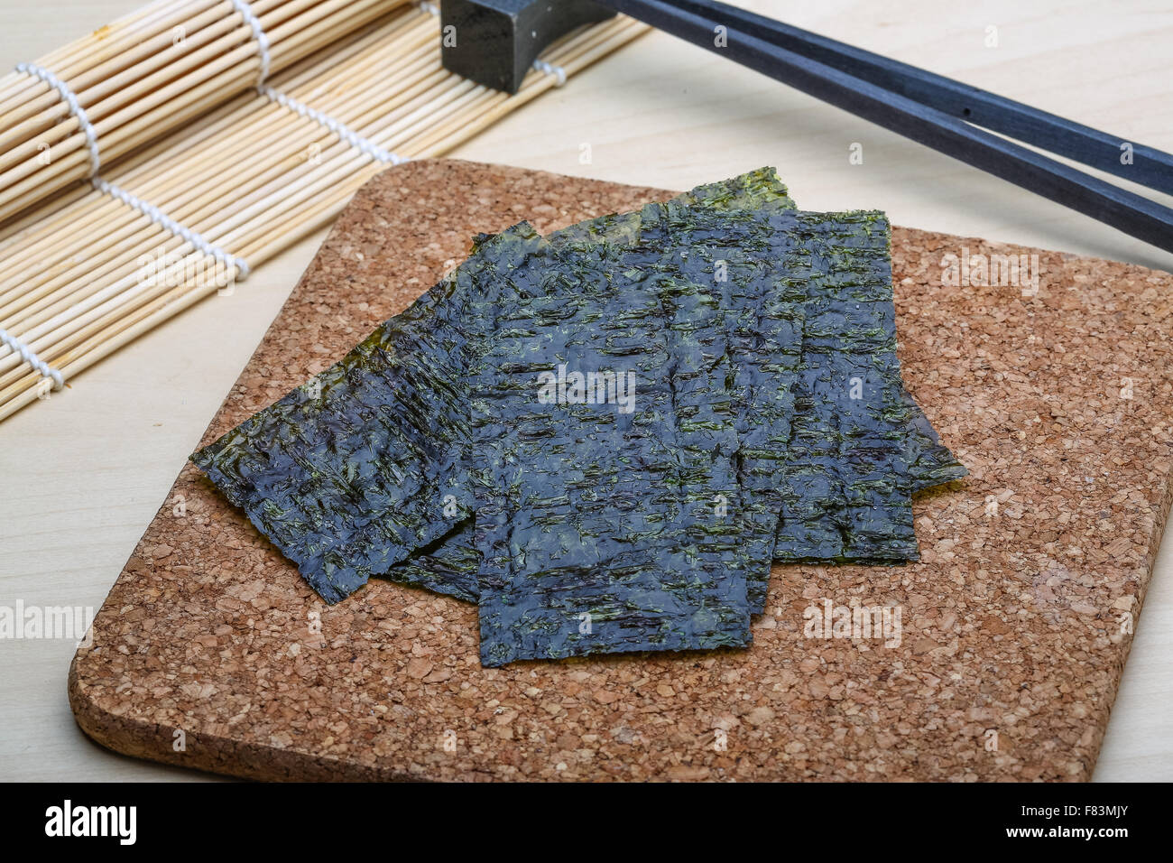 Nori sheets with sticks on the wood background Stock Photo - Alamy