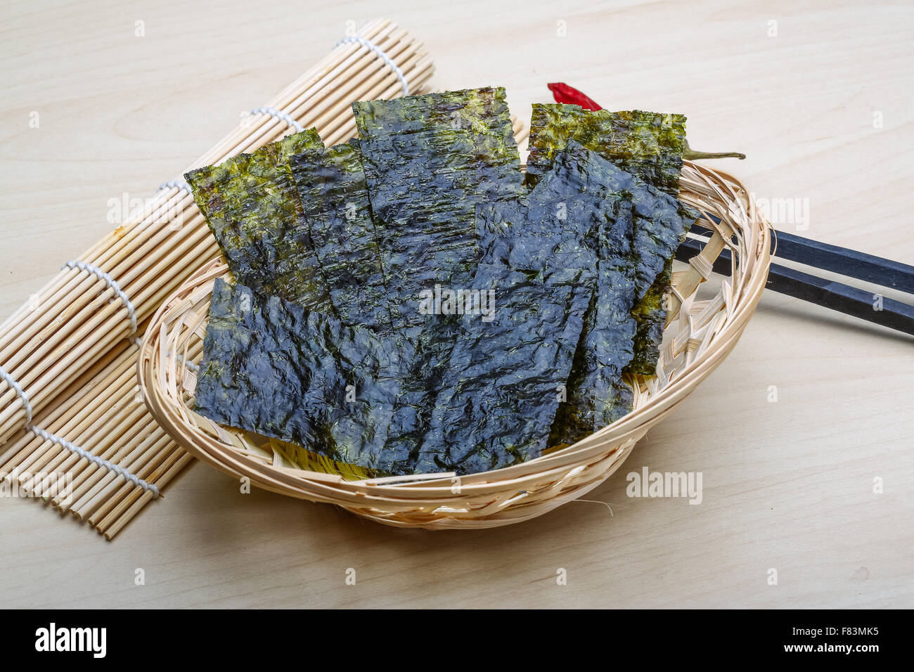 Nori sheets with sticks on the wood background Stock Photo - Alamy