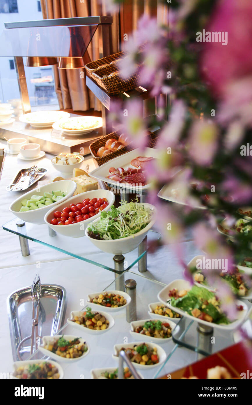 Assorted fresh salads displayed on a buffet, individual containers at ...